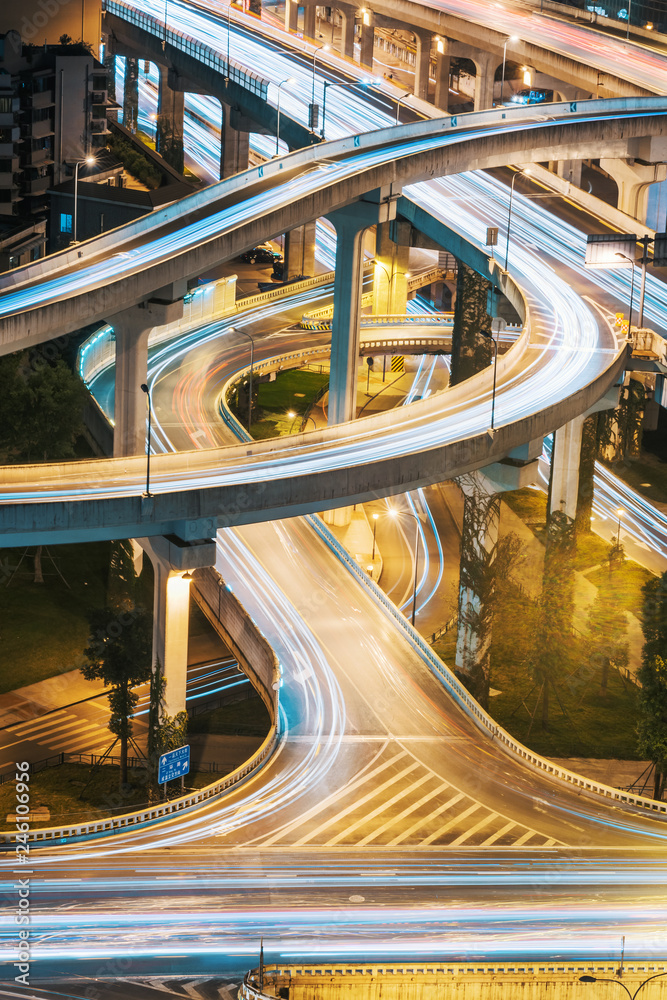 Urban elevated road junction and interchange overpass at night in ...