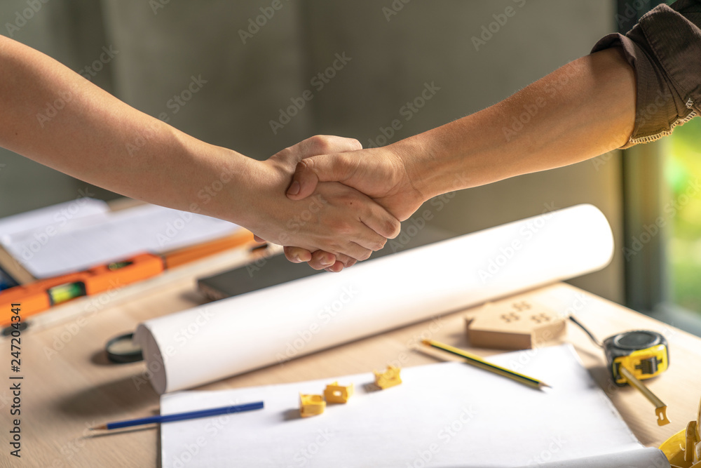 Owner and constructor is agree and shake hands to celebrate in success ...