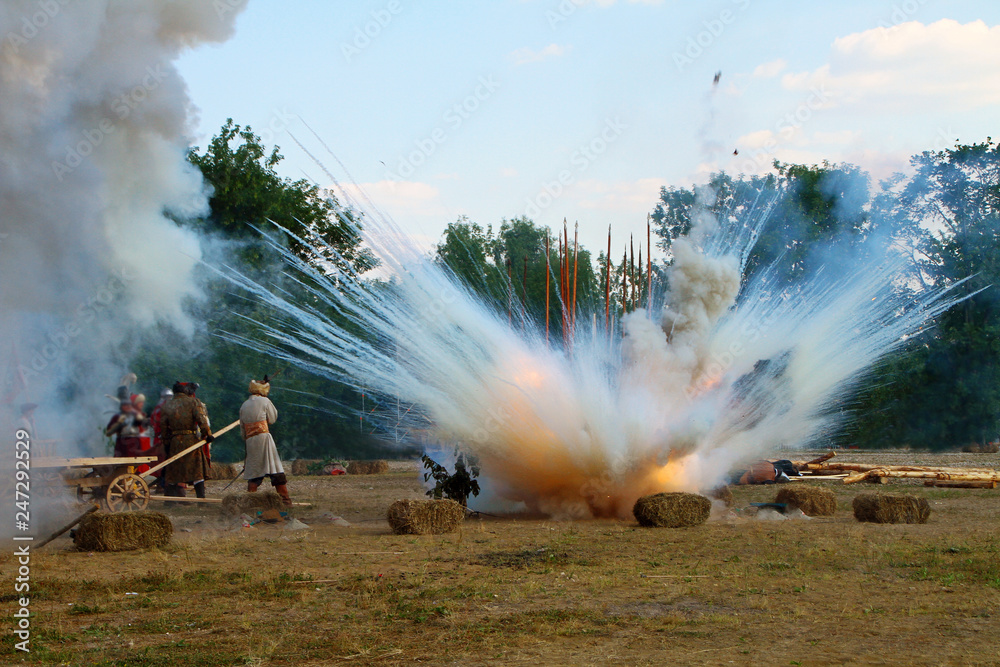 Fotografie Massive bomb explosion during re-enactment of medieval ...