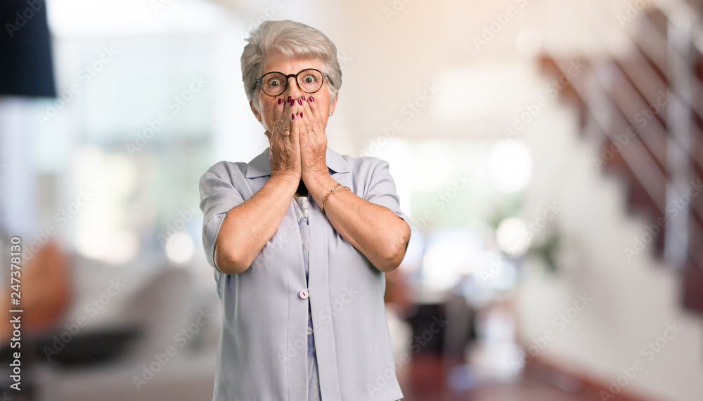 Beautiful senior woman very scared and afraid, desperate for something ...