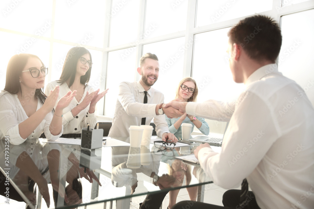 HR Manager shaking hands with new employee. Stock Photo | Adobe Stock