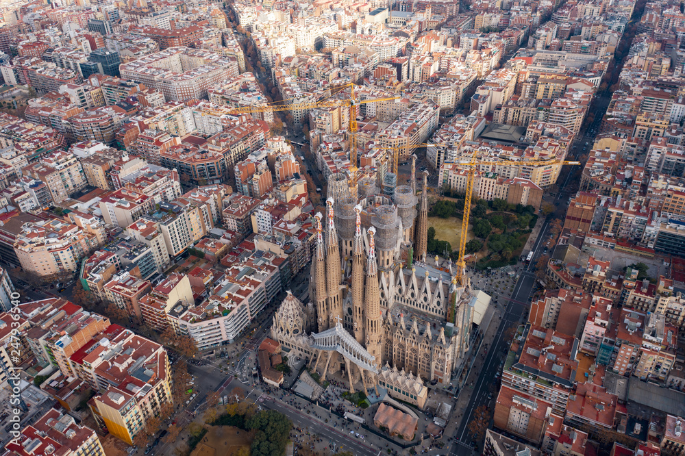 Aerial; drone view of main Gaudi project Sagrada Familia Temple; majestic building towering over ...