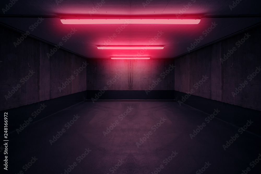 dark underground room with red neon light in basement or parking lot ...