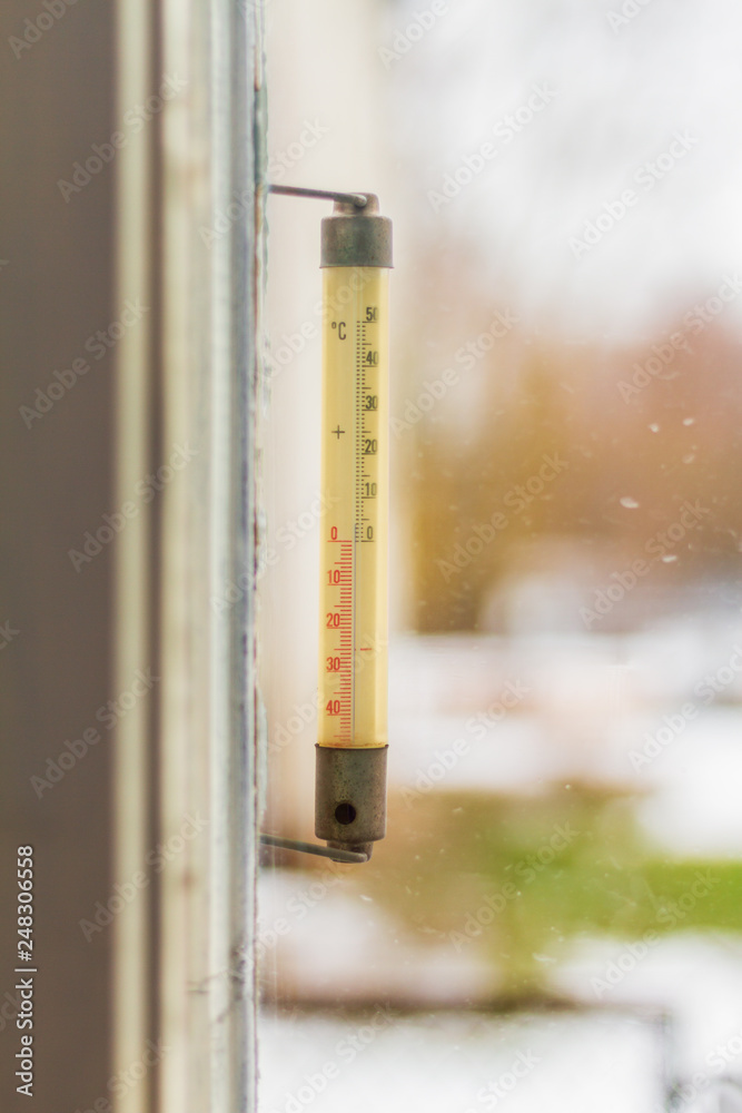 Old vintage thermometer isolated indicating cold temperature above zero ...