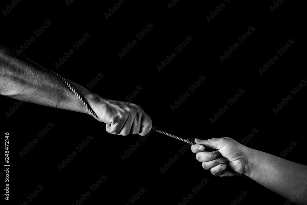 Helping hand concept, hands pulling rope, giving help, care and support ...