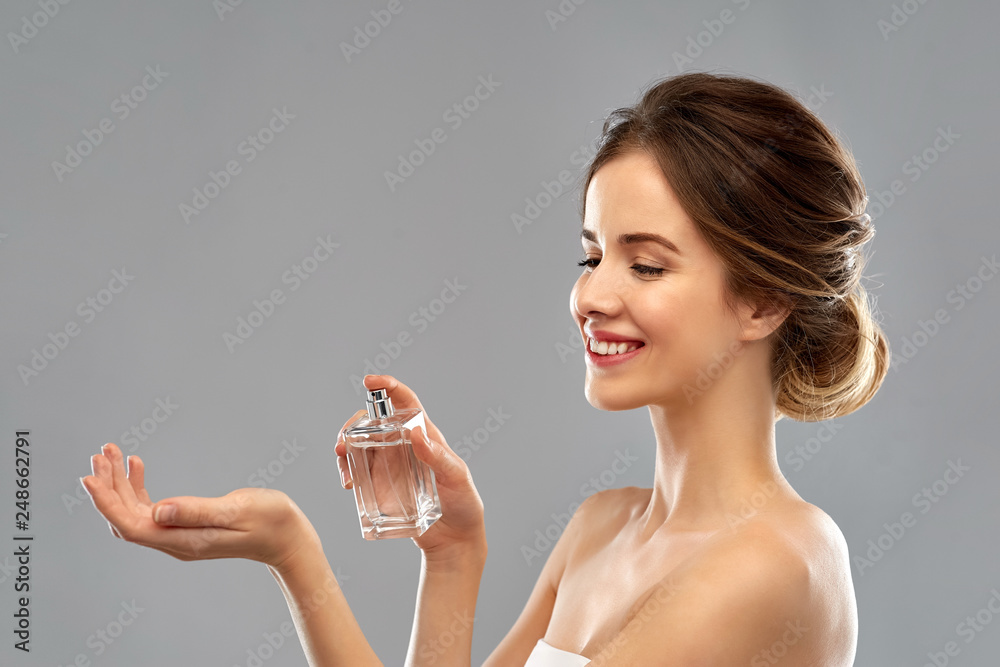 perfumery, beauty and luxury concept - happy smiling young woman ...