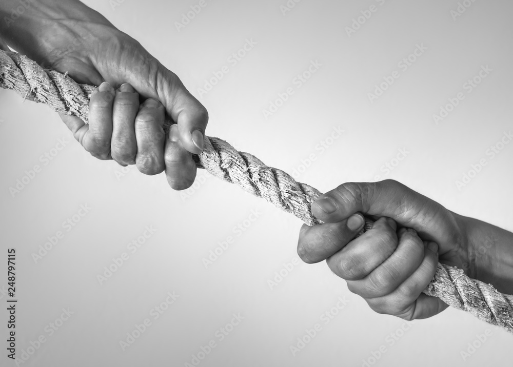 Hand holding a climbing rope, strength and determination. Rescue, help, people Conflict, tug of ...