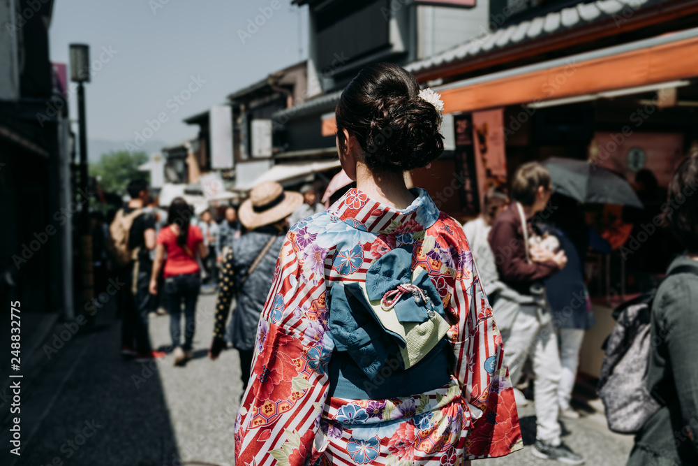 back view of japanese young girl in flower kimono dress walking in ...