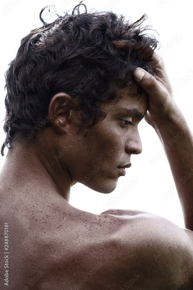 Profile portrait of a fit, bare-chested man with black hair and strong ...