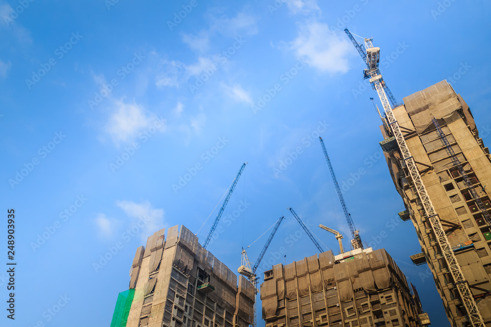 Luffing jib tower crane at high rise building construction site project ...