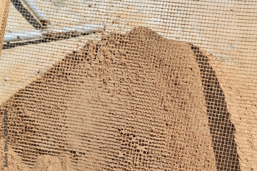 sifting sand through a grid at a construction site Stock Photo | Adobe ...