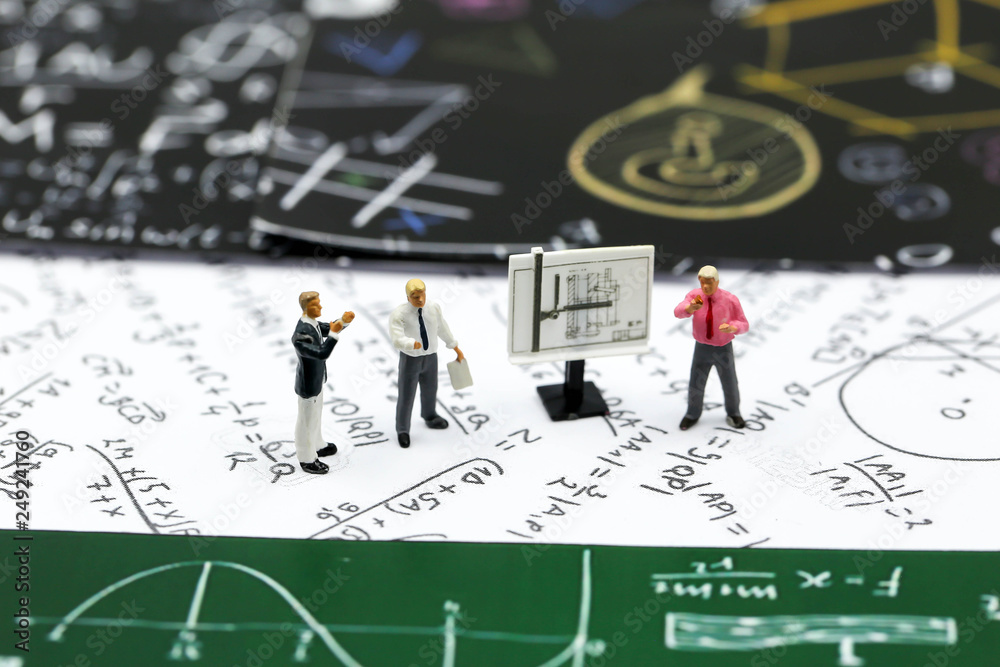 Miniature people : teacher and friend with Math problems on graph paper ...