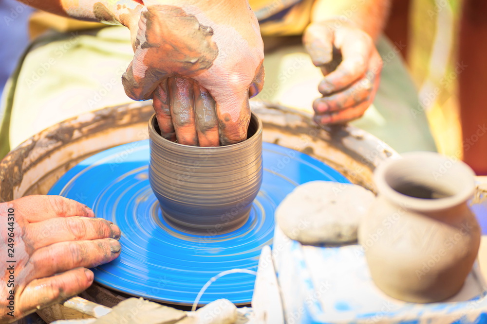 Learning pottery, the hands of the potter direct the student's hands ...