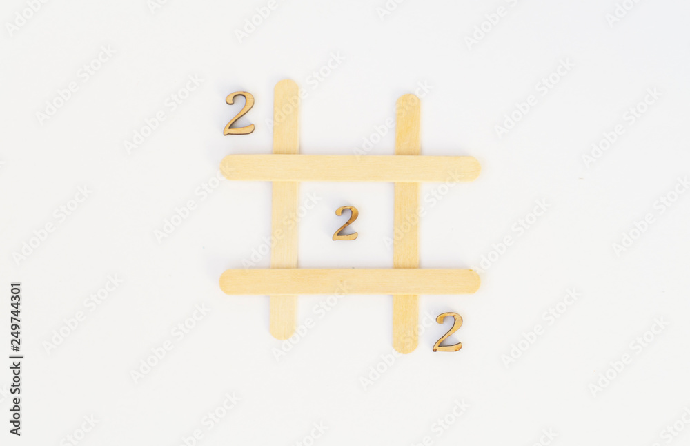 Three figures of two in the game tic tac toe stand in a row in the grid ...