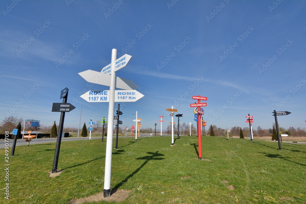 Direction signs in wood showing the distance of the main towns of the ...