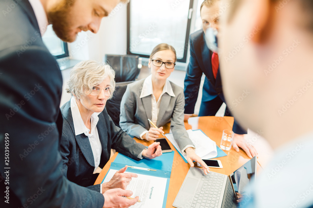 Team of motivated business people driving a project forward Stock Photo ...
