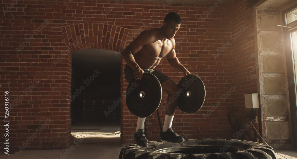 Powerful strong african fighter boxer practicing Weighted Jumps with ...