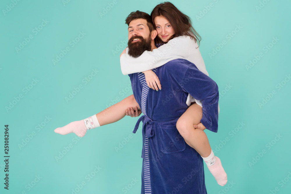 Lets stay at home and have fun. Couple in bathrobes having fun ...
