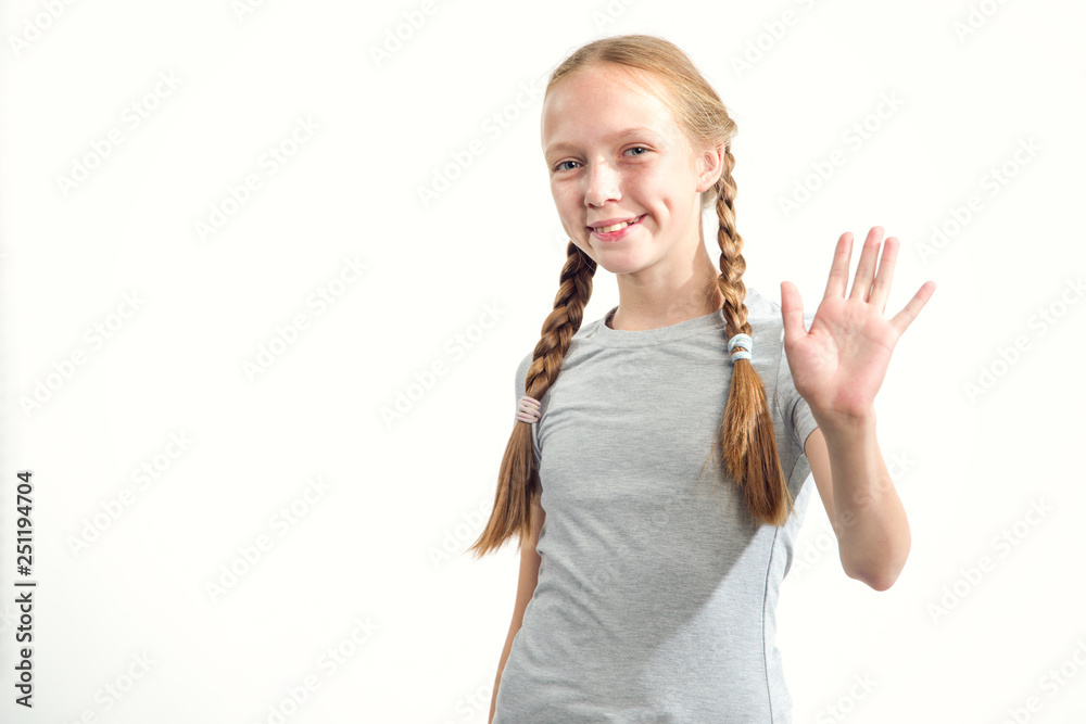Hello! Teen girl waving her hand in greeting. Portrait of a young happy ...