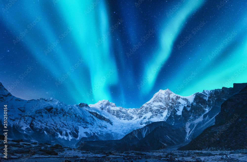 Aurora borealis above the snow covered mountain range in europe ...