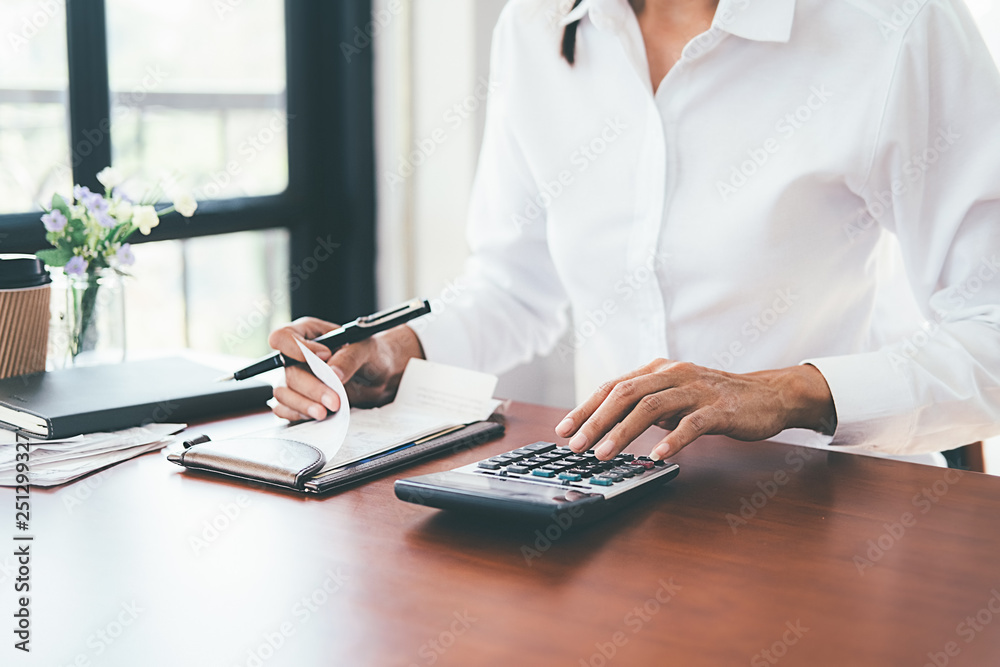 Woman with bills and calculator. Woman using calculator to calculate ...