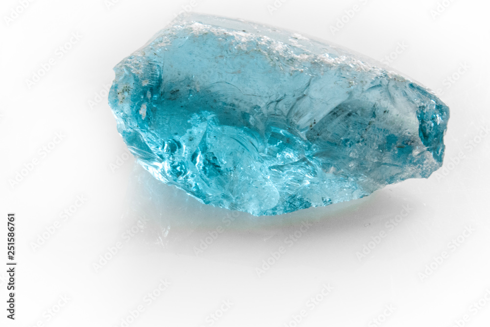 raw blue topaz gem on white background Stock Photo | Adobe Stock