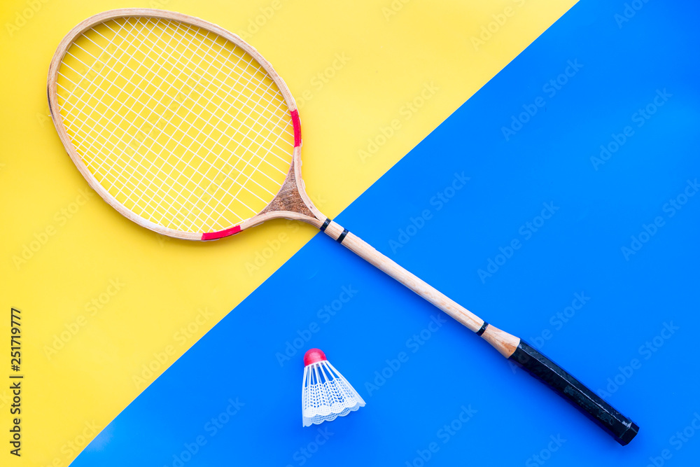 Badminton equipment. Badminton racket and shuttlecock on yellow and ...