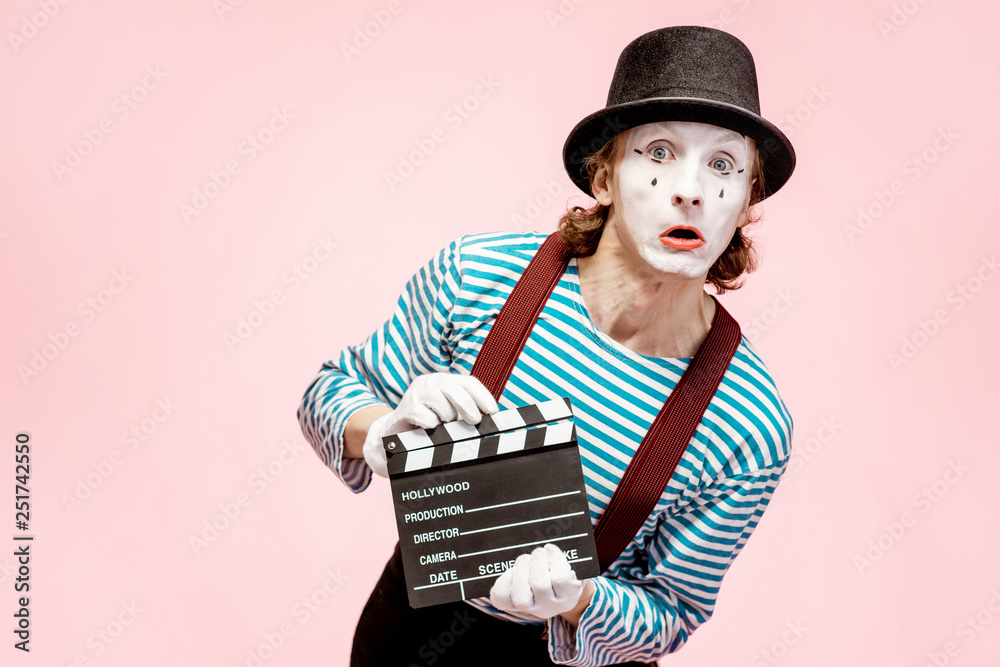 Portrait of an actor as a pantomime with cinematography clapperboard on ...
