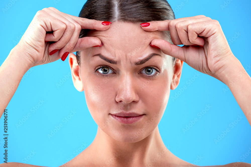 Signs of aging. Portrait of shocked young woman is looking at camera ...