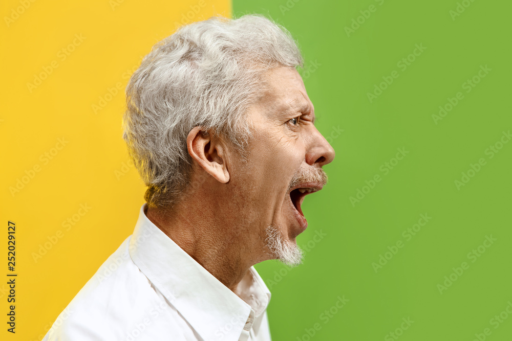 Fotografie Screaming, hate, rage. Crying emotional angry man screaming ...