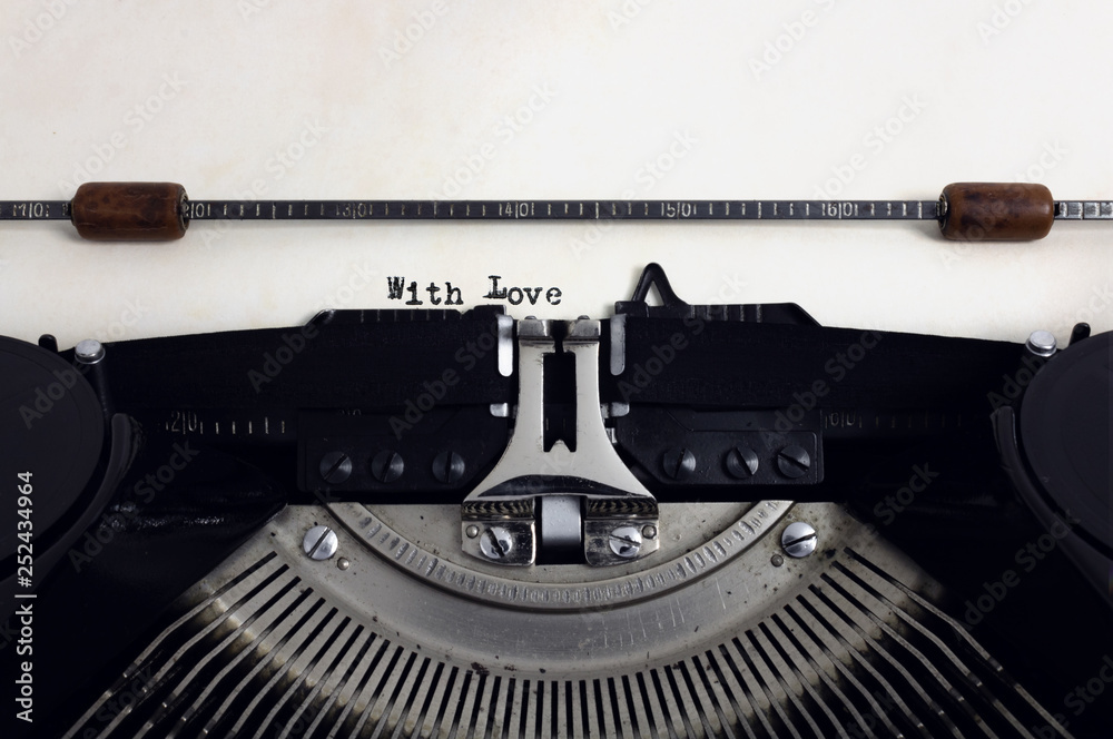Old retro vintage black typewriter with close-up typing text With love ...
