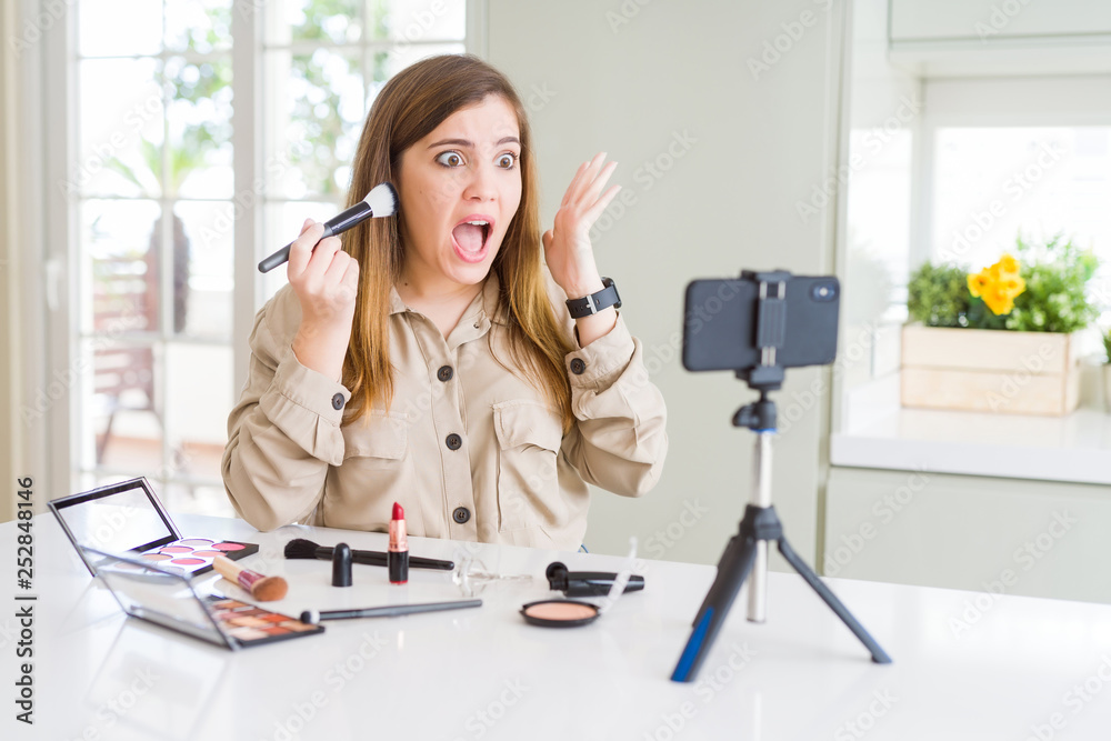Beautiful young influencer woman recording make up video tutorial very ...