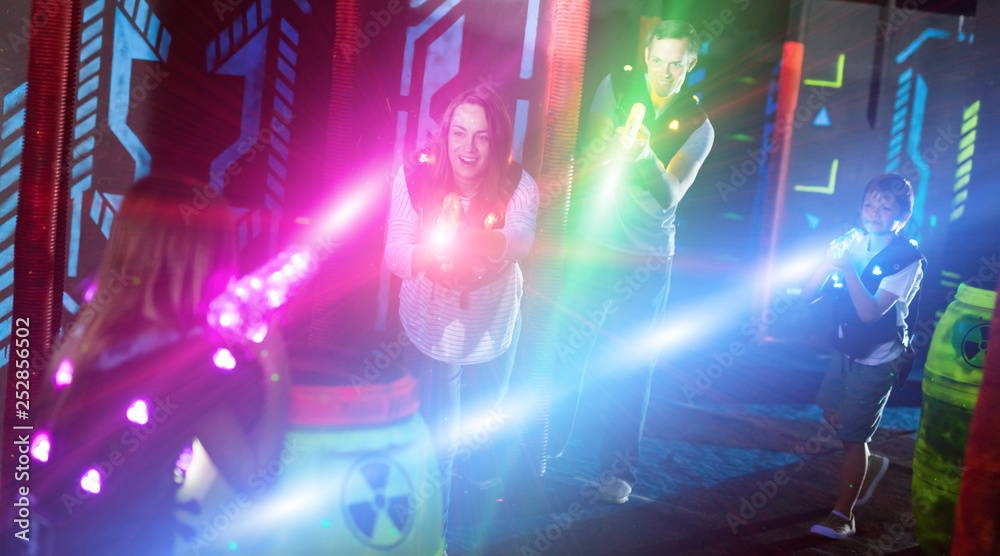 Kids and parents in beams during laser tag game Stock Photo | Adobe Stock