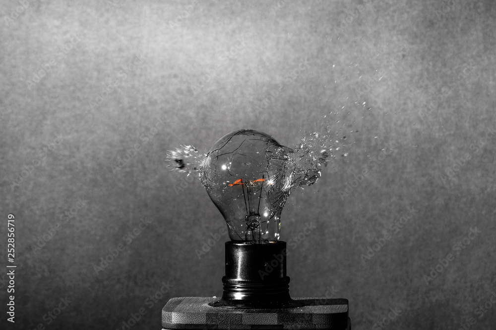 Highspeed capture of an red glowing light bulb shattered to peaces ...