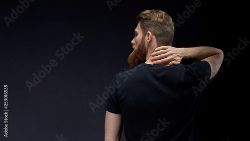 Man turned his back and put hand around neck Stock Photo | Adobe Stock