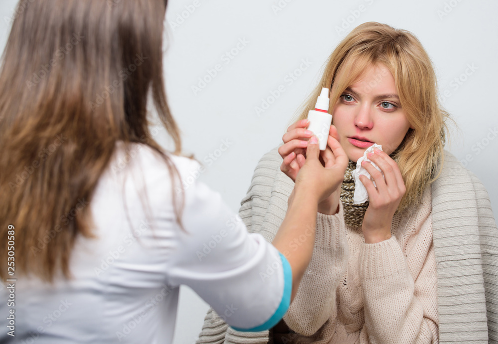 It can help clear her sinuses. Medical doctor examining patient ...