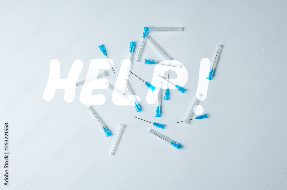 Hypodermic syringe with HELP word . Syringes with blue needles. Medical ...