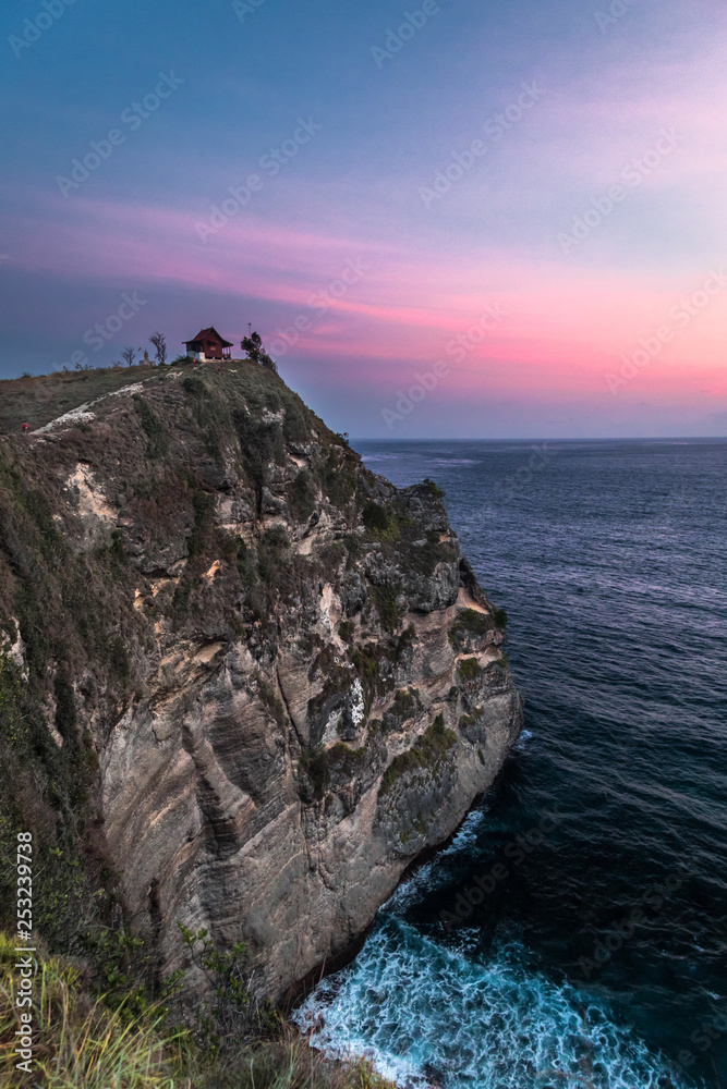 Pink sunset at Atuh beach on Nusa Penida island in Indonesia with a ...