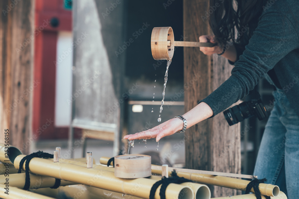 Washing hands at water pavilion in Japanese temple osaka japan. female ...