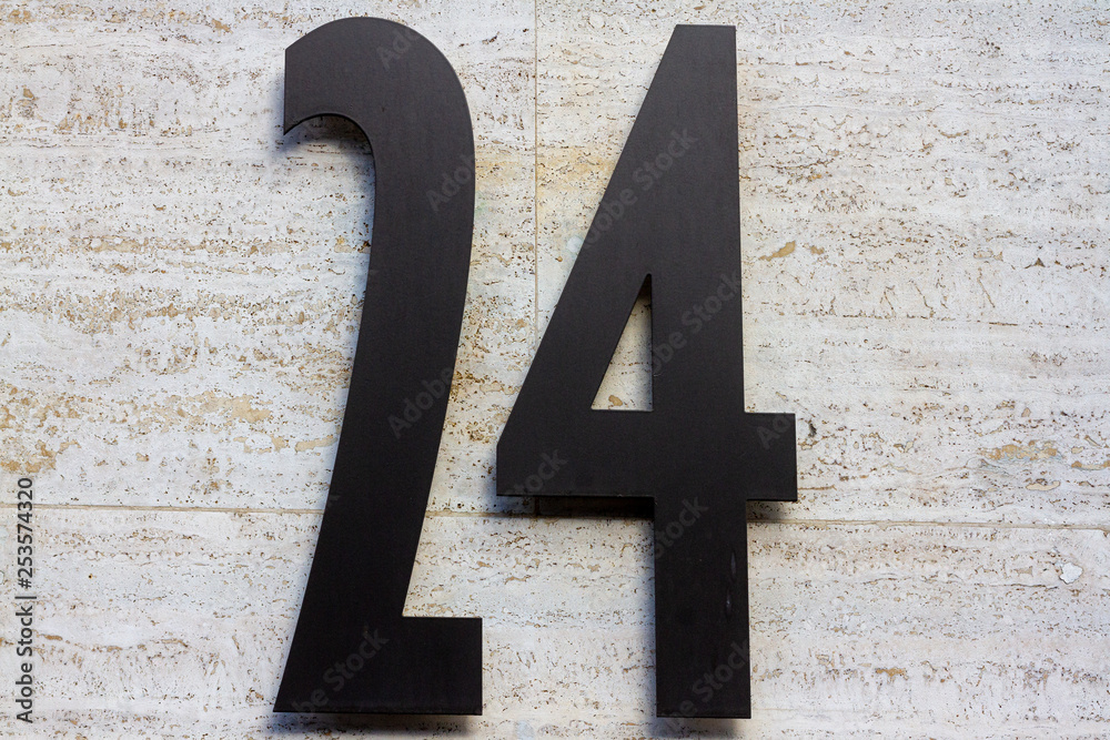 Horizontal version of number twenty-four in black l=numbers on a marble ...