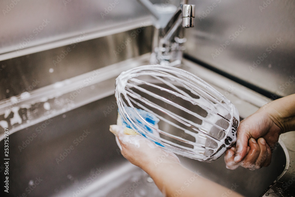 .Working woman cleaning kitchenware to prepare bread and buns at her ...
