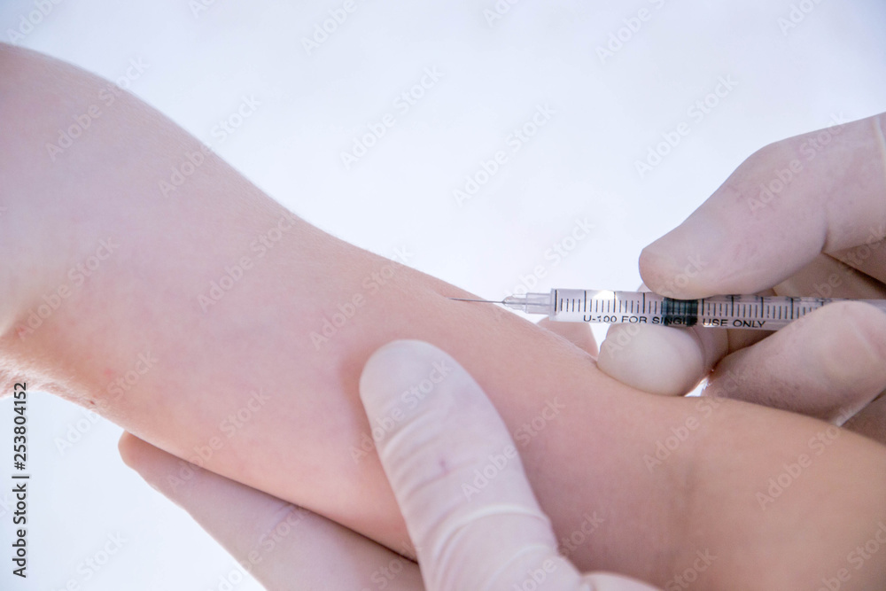 Hand with syringe for injection. Vaccination against influenza and ...