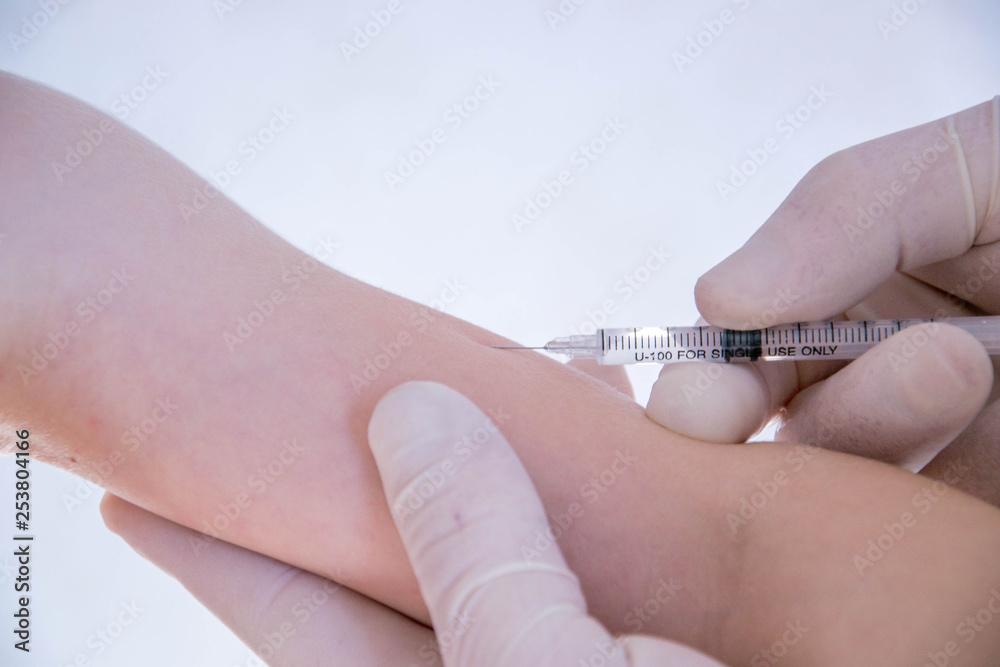 Hand with syringe for injection. Vaccination against influenza and ...