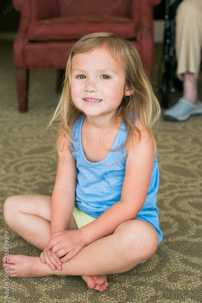 Little Girl Sitting on Floor Stock Photo | Adobe Stock