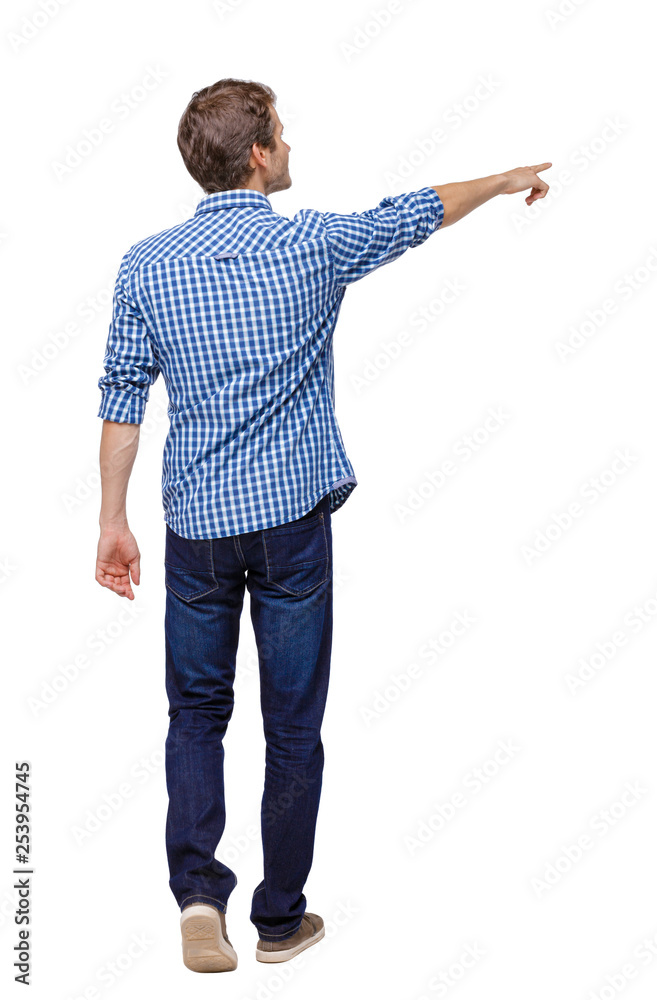 Back view of a man walking with a pointing hand. Stock Photo | Adobe Stock