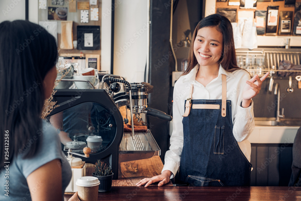 woman barista talking with customer about tasted of coffee cup with ...