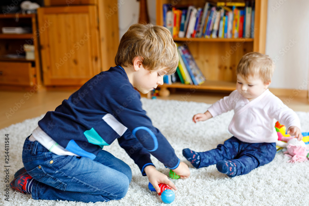 Happy little kid boy with cute little baby girl, cute sister. Siblings ...