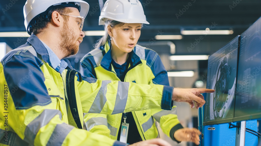 Inside Factory Male Mechanical Engineer and Female Chief Engineer Work ...