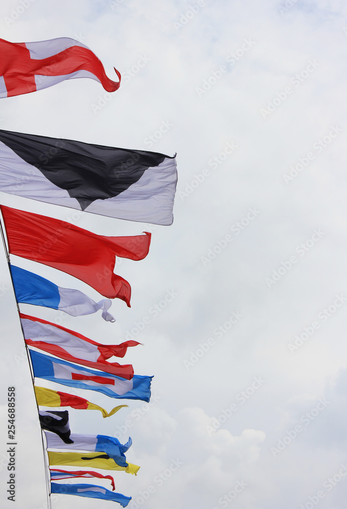 Navy signal flags and pennants isolated on empty sky background ...