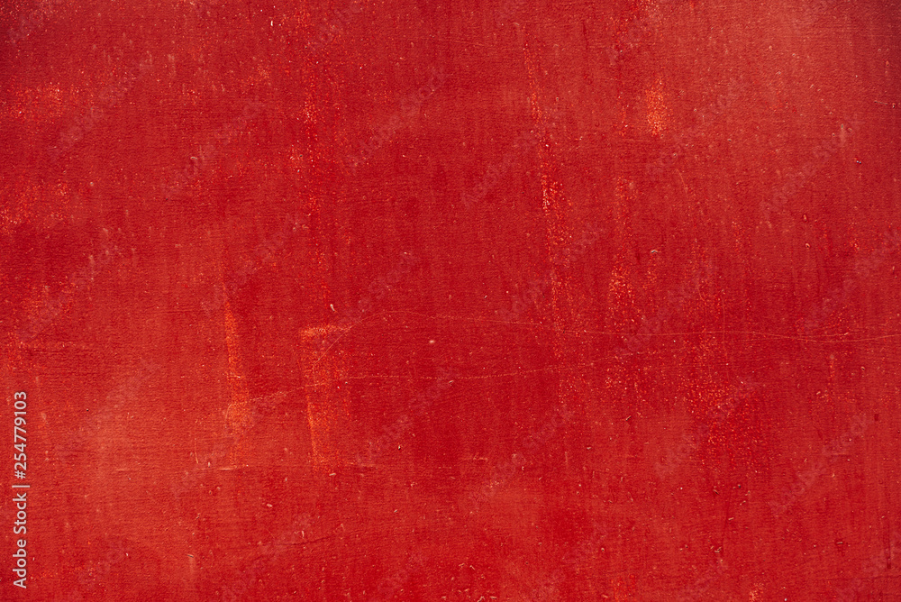 Imperfect metallic plate. Scratched vivid red paint surface close-up ...